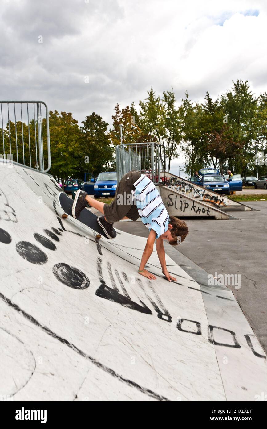 boy is skating at the pipe and tumbles Stock Photo - Alamy