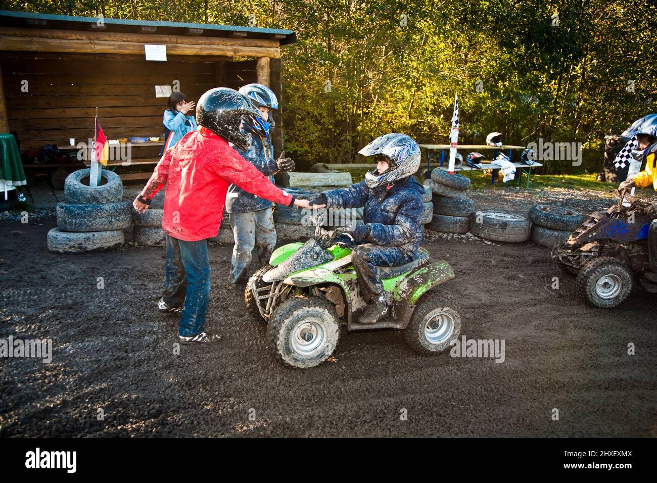 child loves to race with a quad bike at the muddy quad track Stock ...