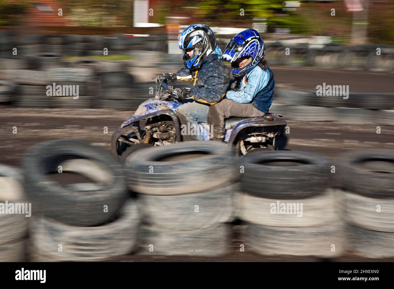 child loves to race with a quad bike at the muddy quad track Stock ...