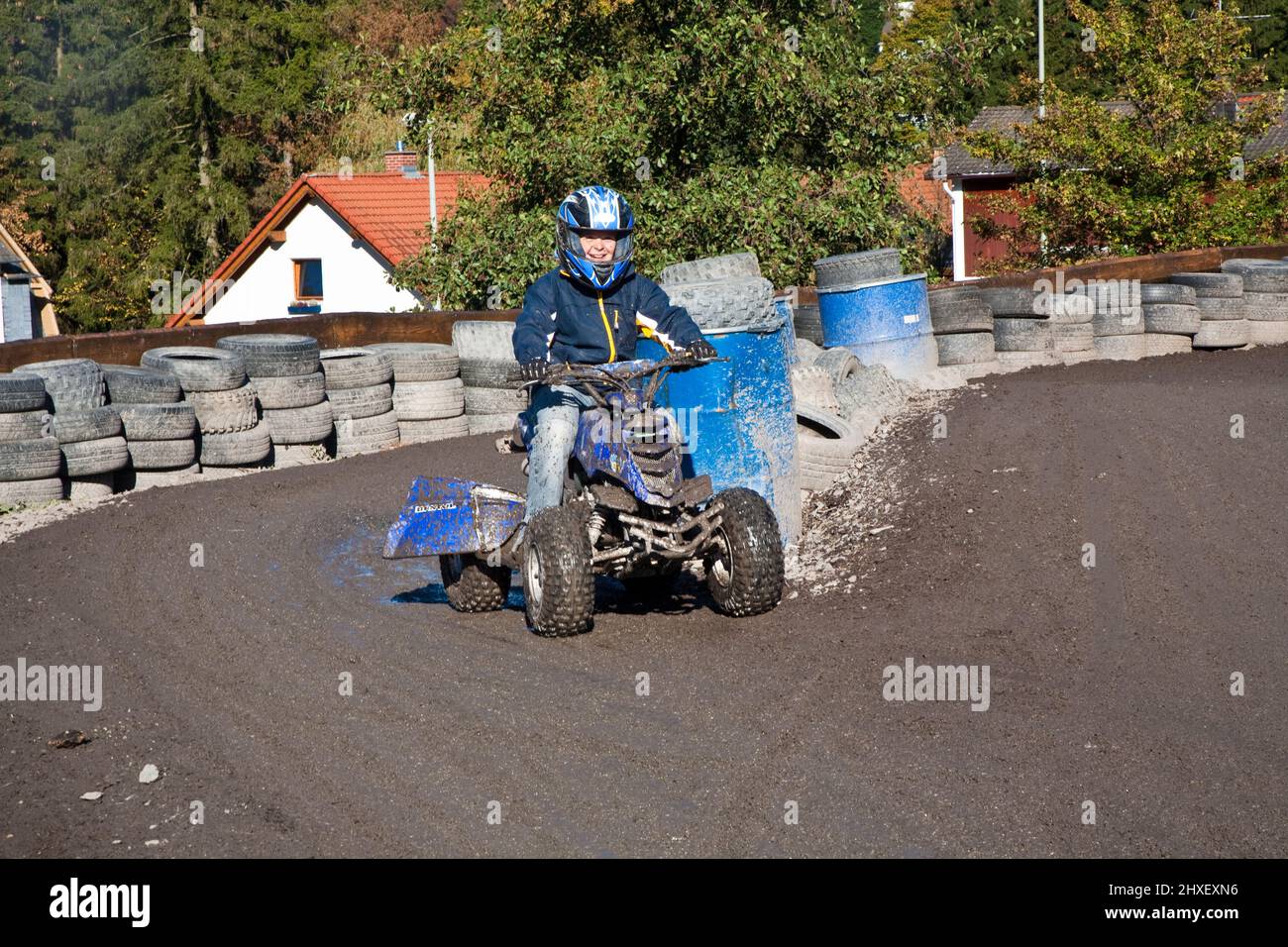 child loves to race with a quad bike at the muddy quad track Stock ...