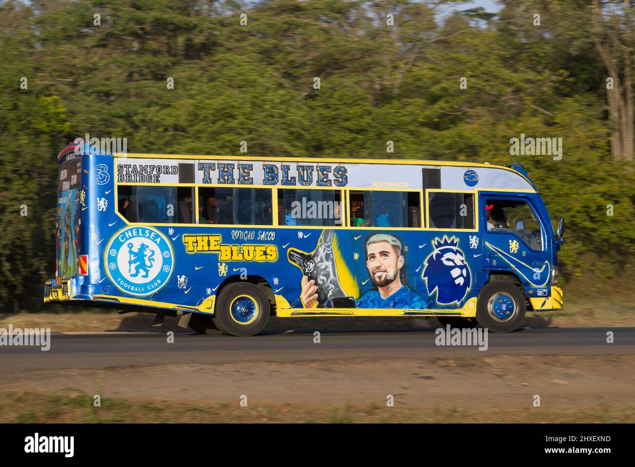 Bus with customised paintwork driving along Magadi Road, Langata. Many ...