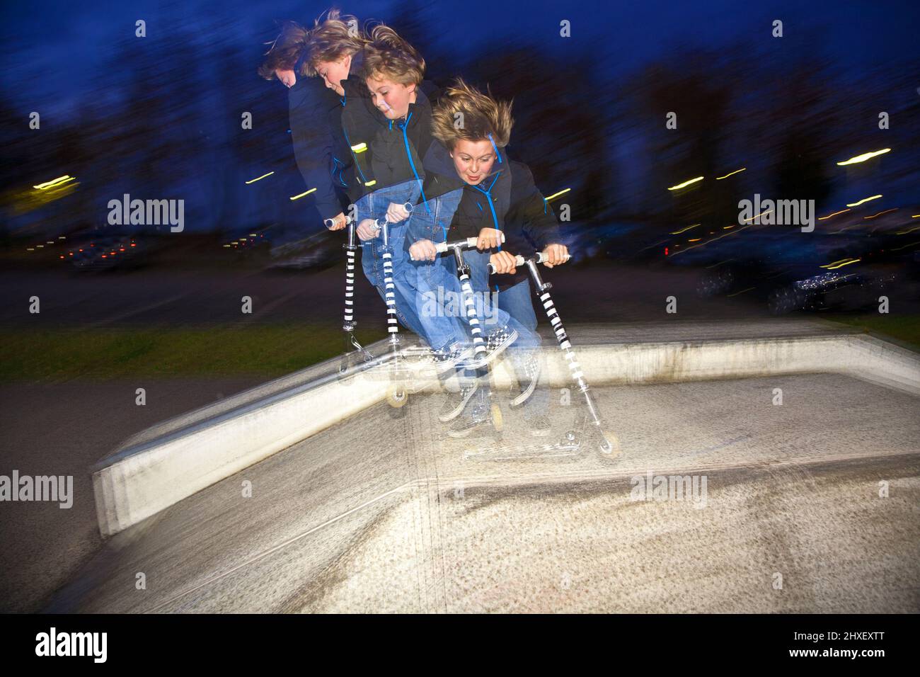 boy jumping over a ramp by night Stock Photo - Alamy