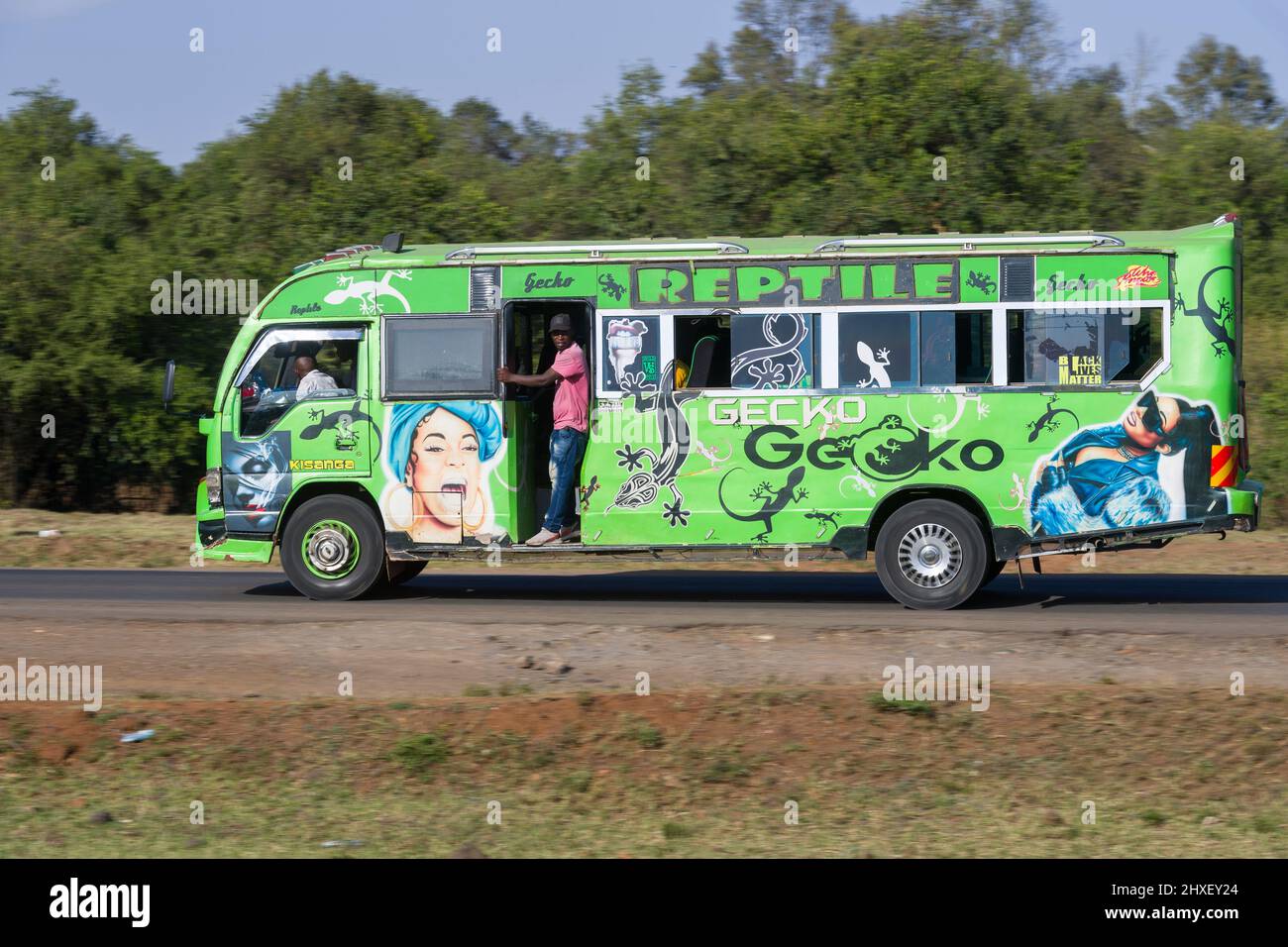 Bus with customised paintwork driving along Magadi Road, Langata. Many ...
