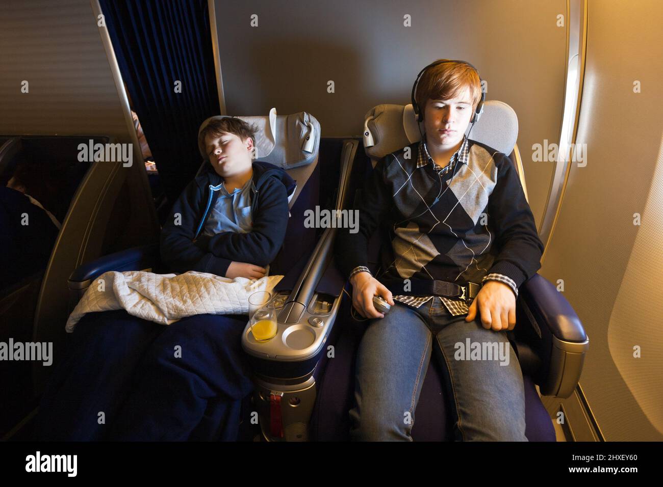 children are relaxing and sleeping in an aircraft in business class ...