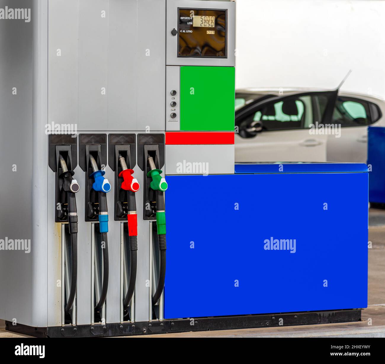 Fuel pump with fill nozzles colored black, blue, red and green ...