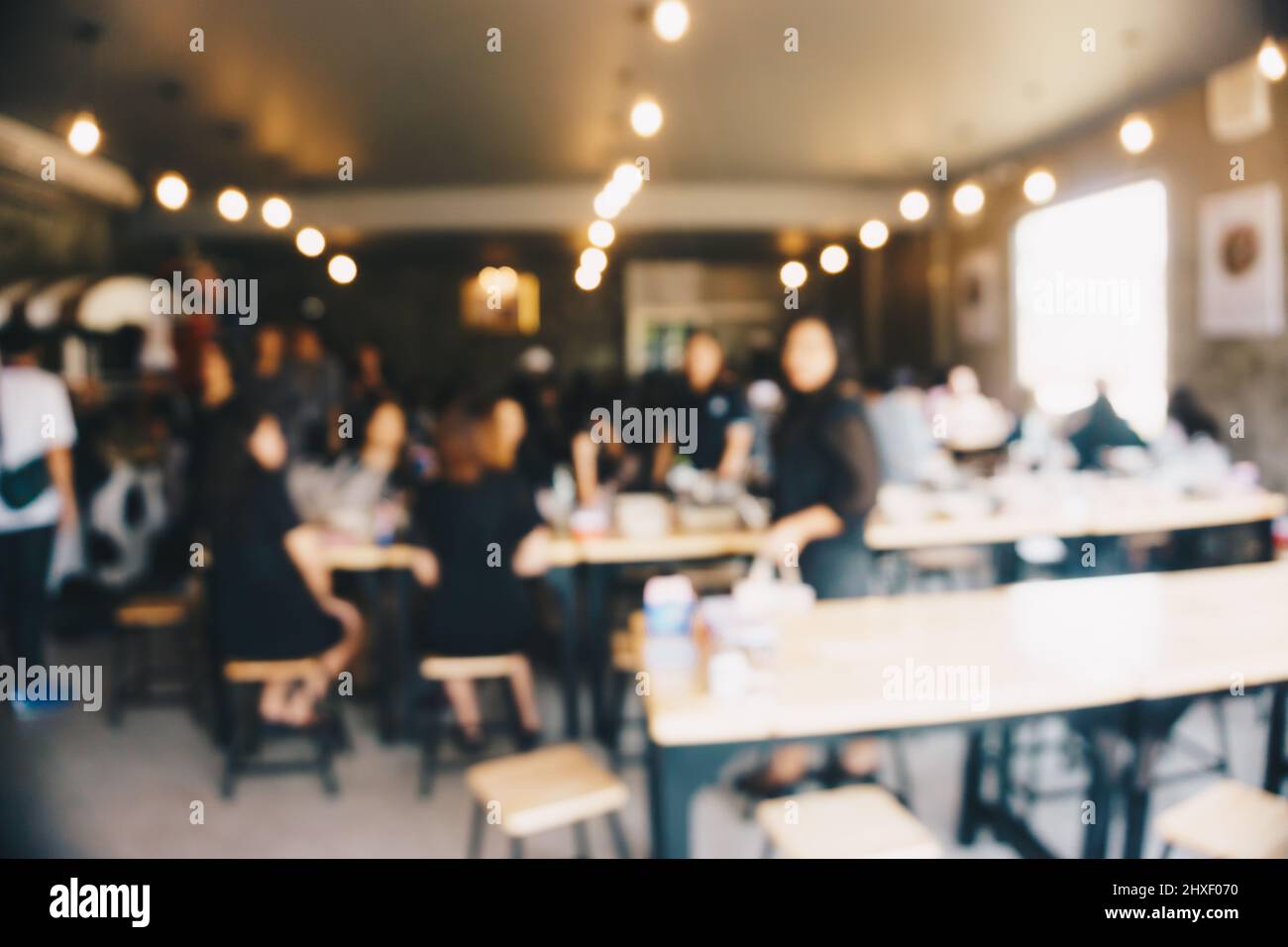 Blurred group of people eating food in restaurant business background ...