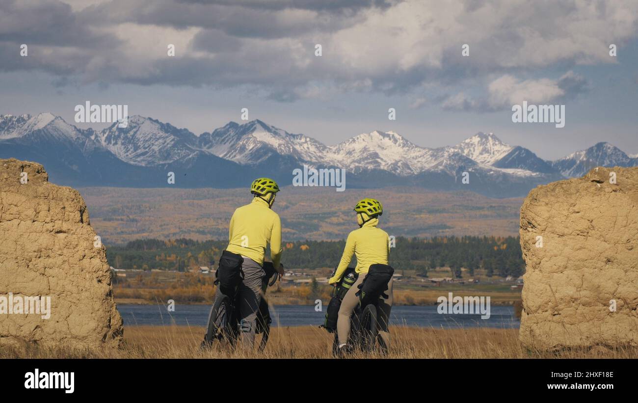 The man and woman travel on mixed terrain cycle bike touring with ...