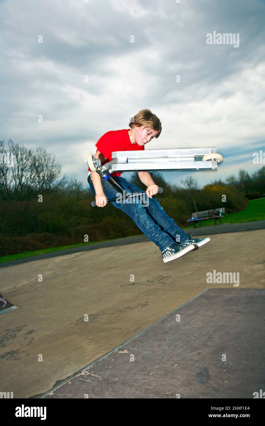 Boy riding a scooter going airborne at a scooter park Stock Photo - Alamy