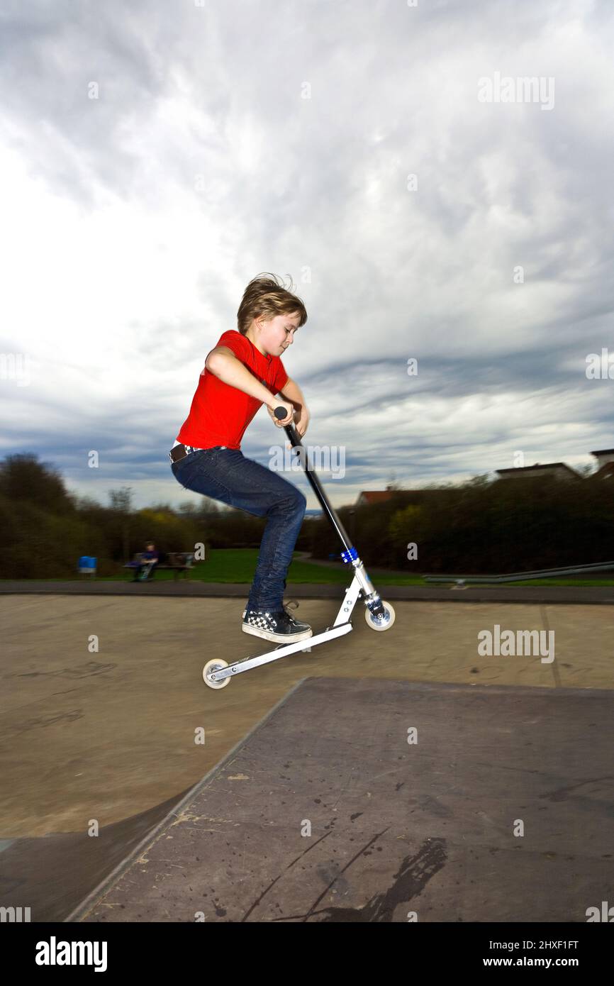 Boy riding a scooter is jumping at a scooter park Stock Photo - Alamy