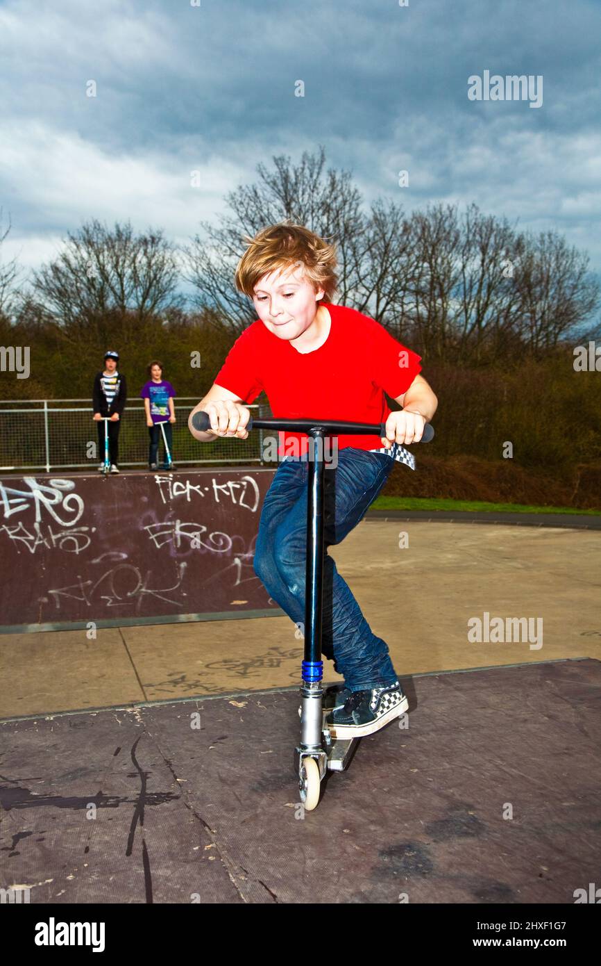 Boy riding a scooter gone airborne on a scooter park Stock Photo - Alamy