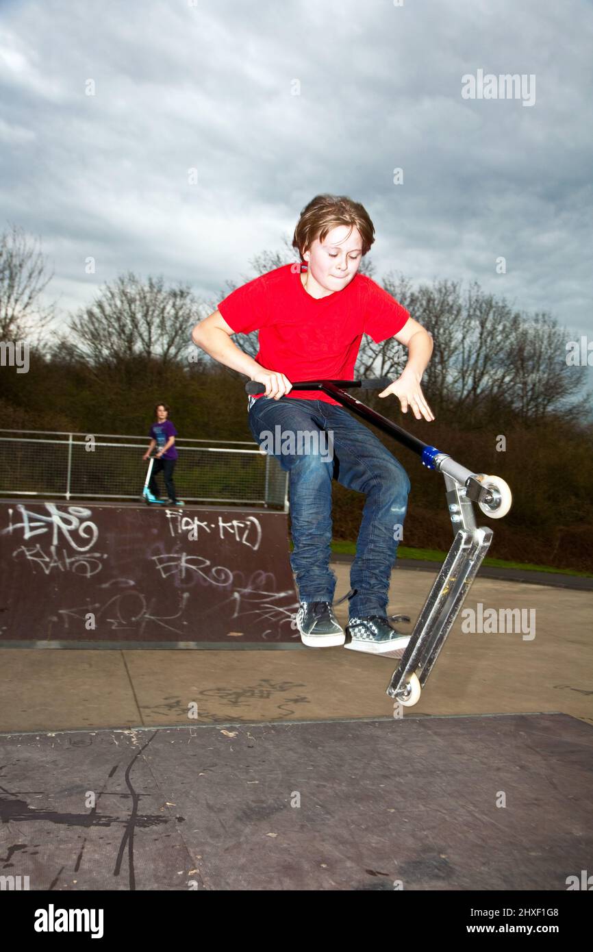 Boy riding a scooter gone airborne on a scooter park Stock Photo - Alamy