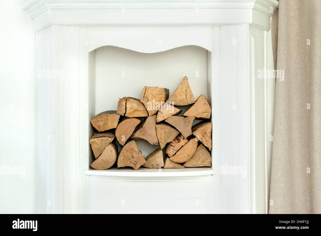 White stone fireplace with firewood without fire Stock Photo - Alamy