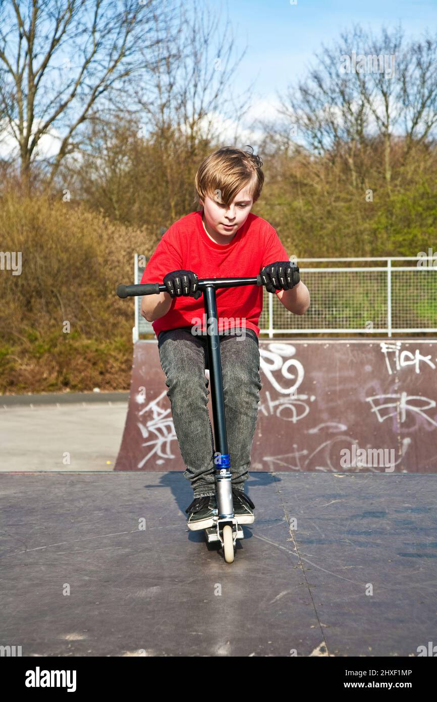 boy jumping with a scooter over a funbox Stock Photo - Alamy