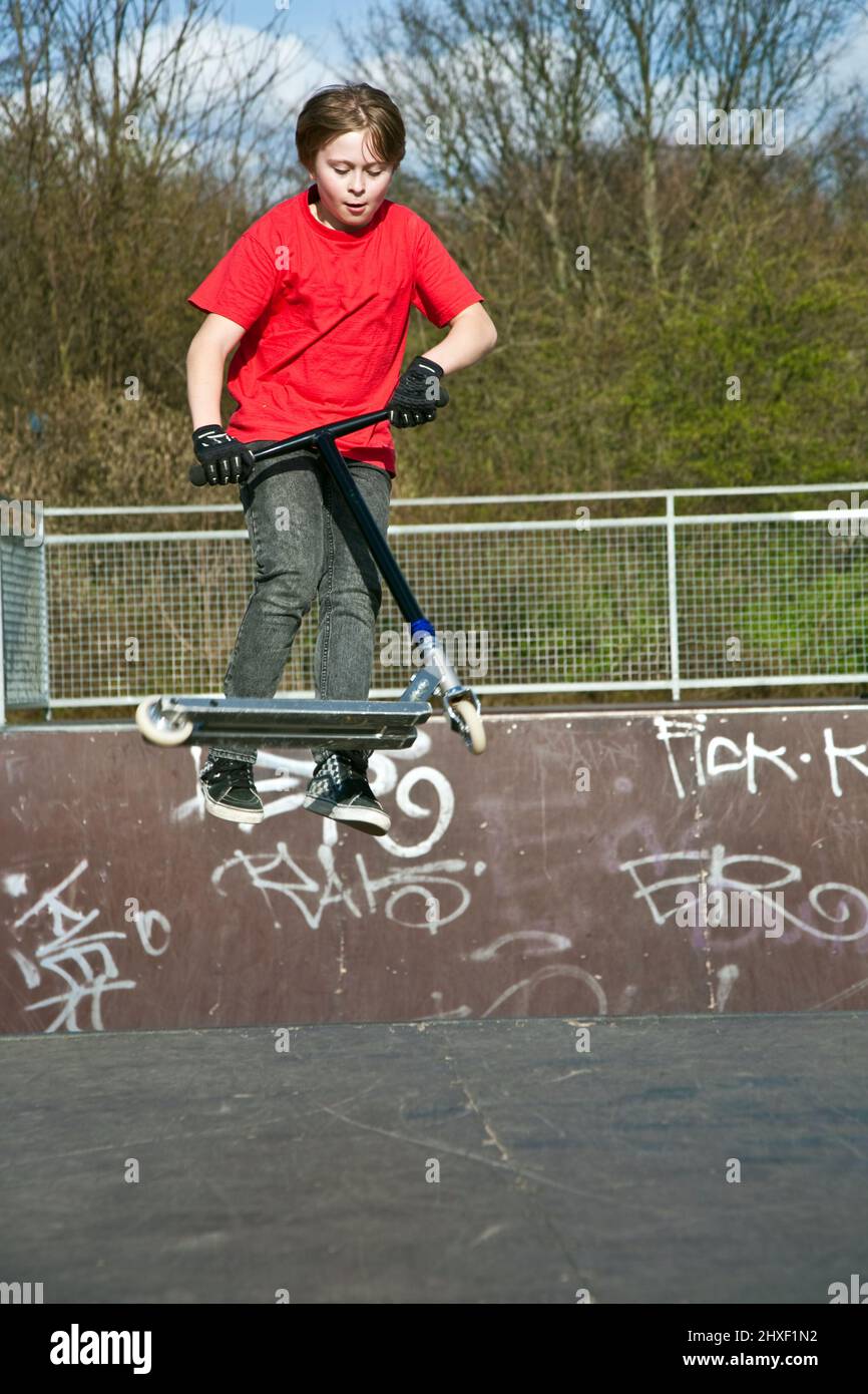 boy jumping with a scooter over a funbox Stock Photo - Alamy
