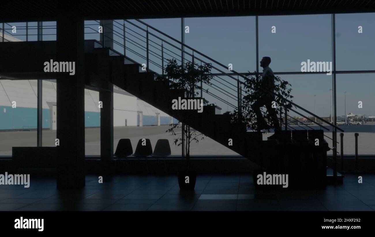 Sunset sky behind the windows of a business center. HDR. People walking ...