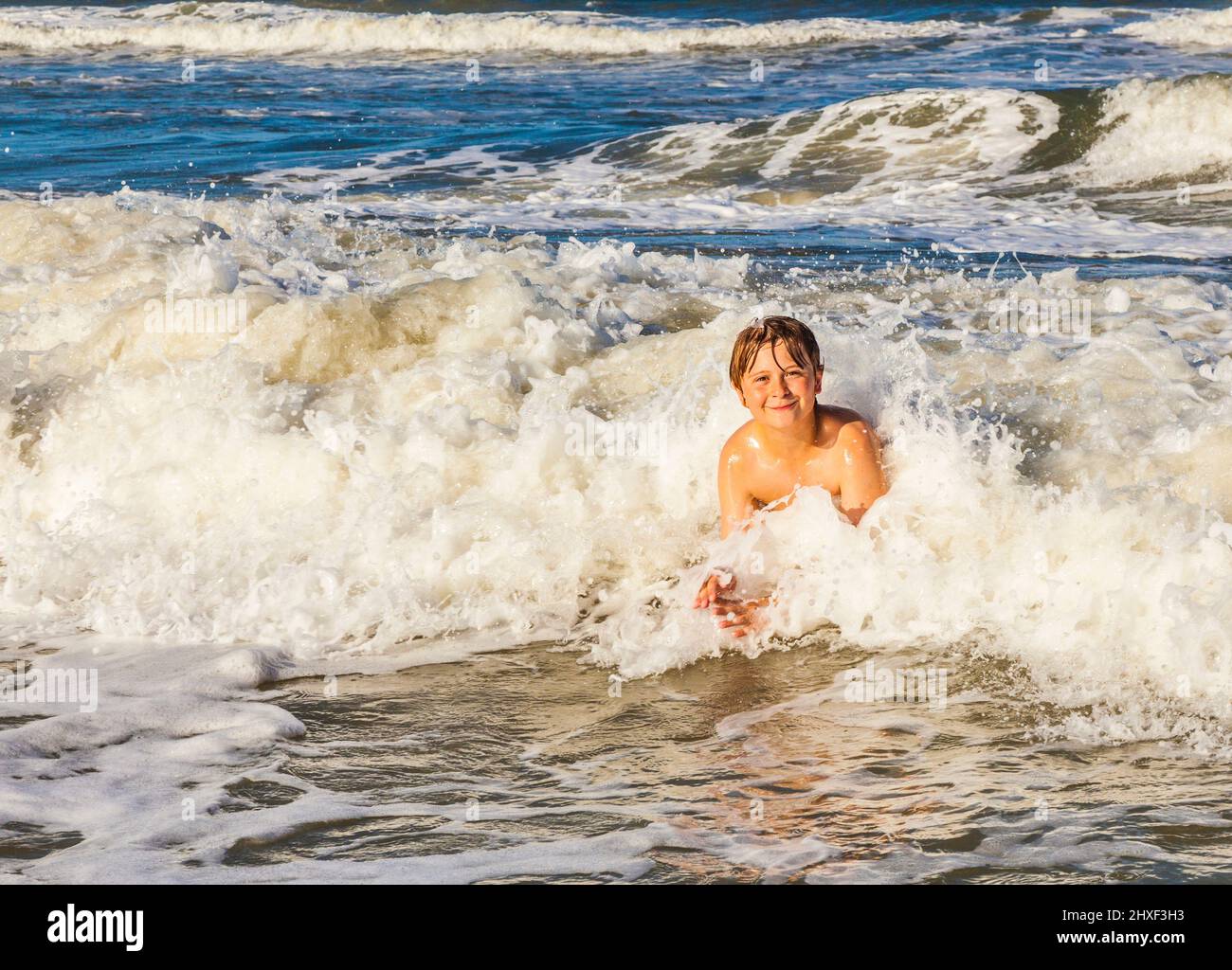 Happy boy jumping in waves hi-res stock photography and images - Alamy