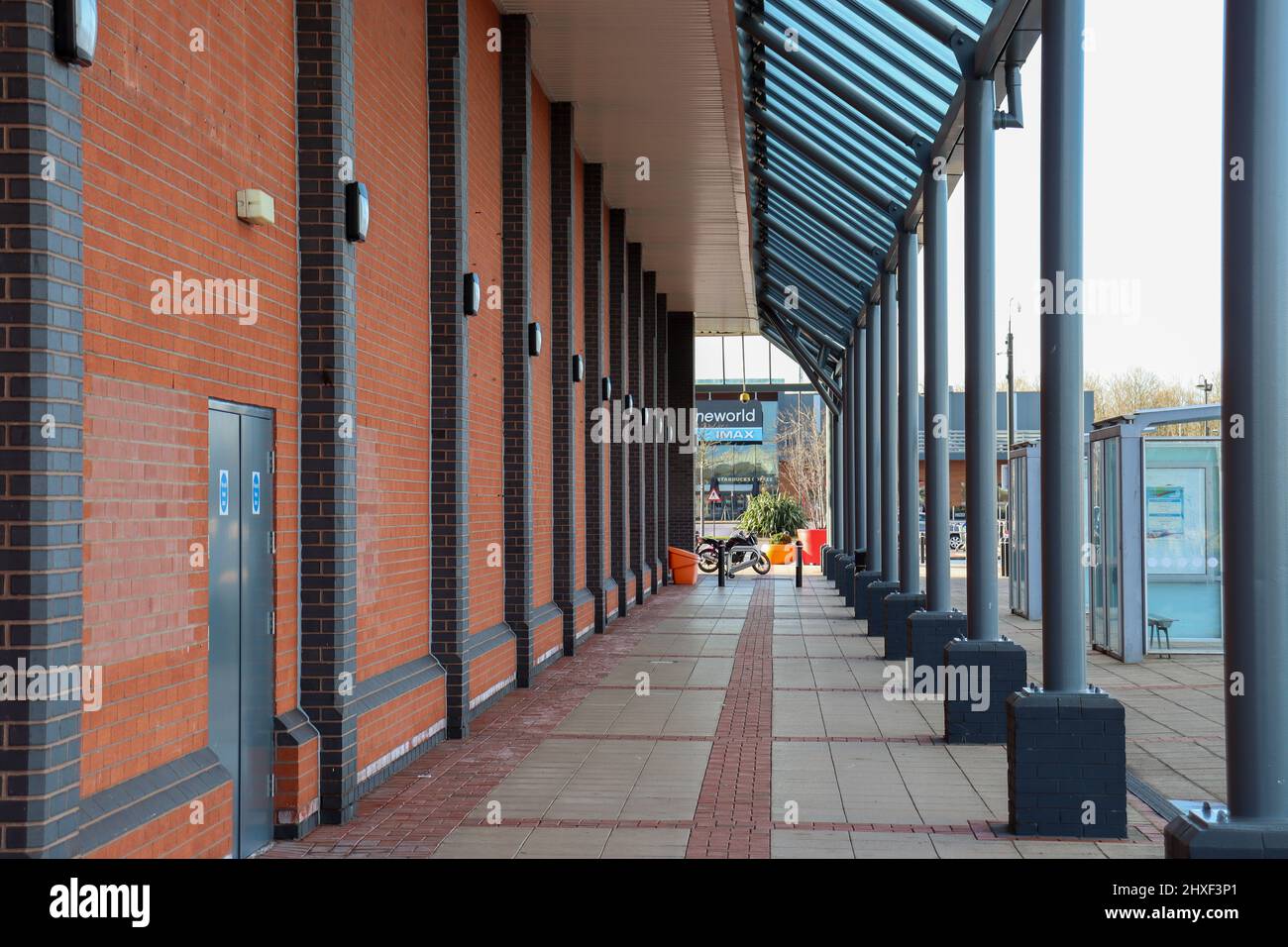 Covered walkway over pavement, along the side of a building Stock Photo ...