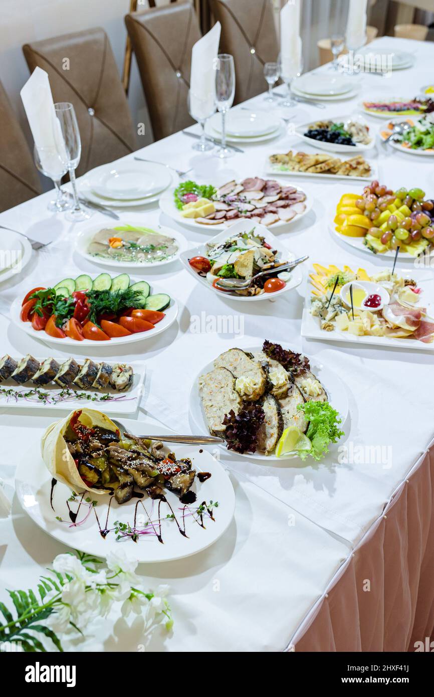 Serving a festive table in a restaurant. Preparation of a banquet for a ...