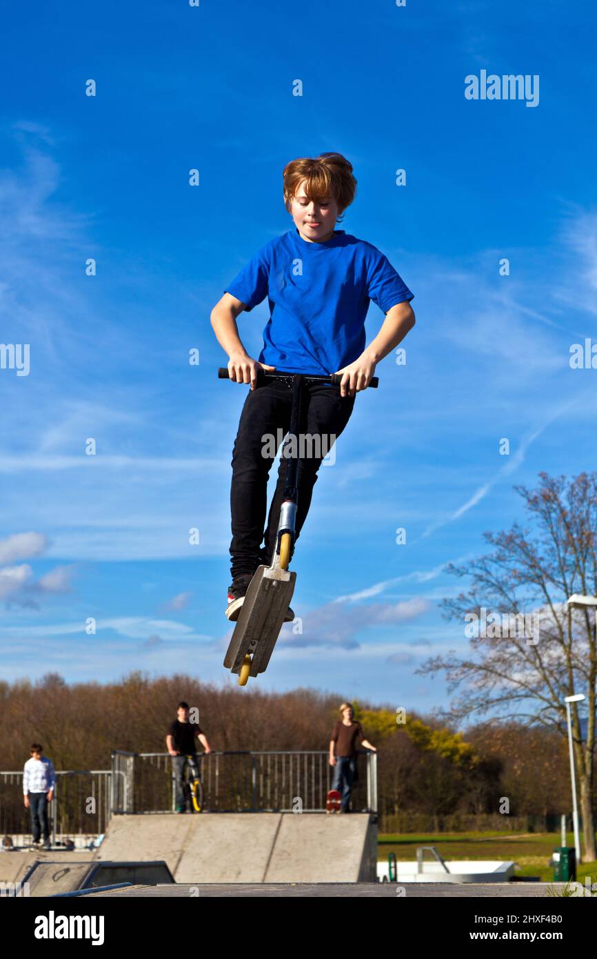 boy jumping with the scooter Stock Photo - Alamy