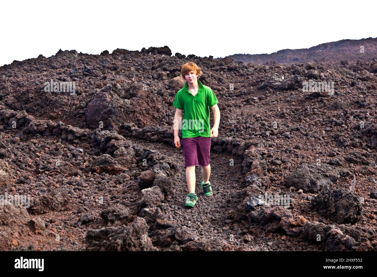 boy walking on volcanic stones in natural parc in lanzarote Stock Photo ...