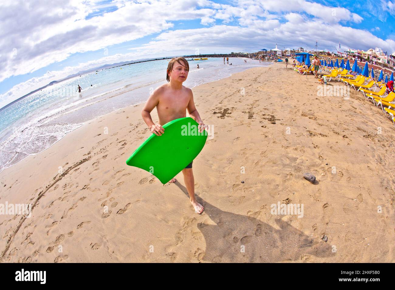 cute boy with surfboard has fun at the beach Stock Photo - Alamy