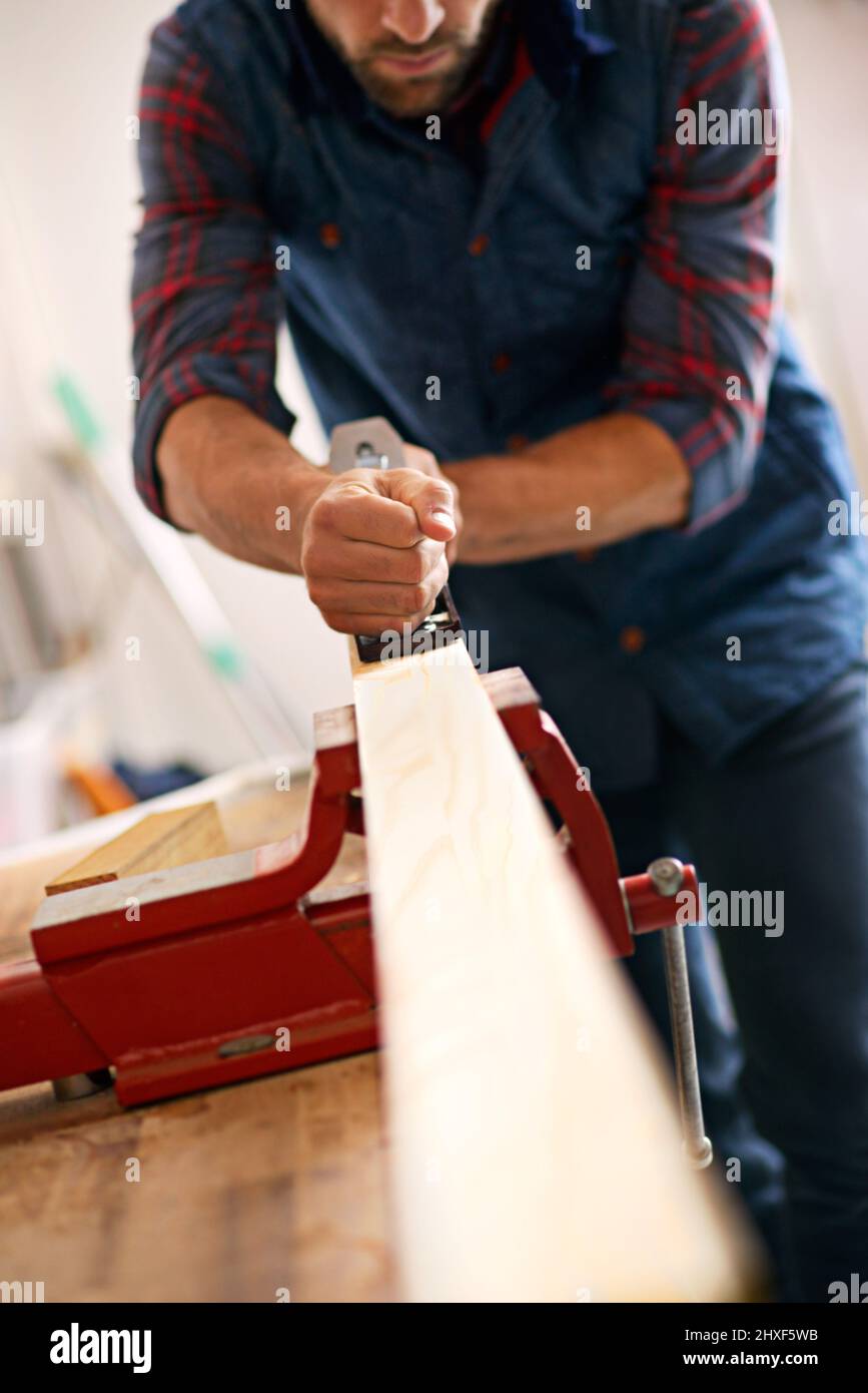 Precision and perfection. Shot of a handsome young carpenter measuring ...