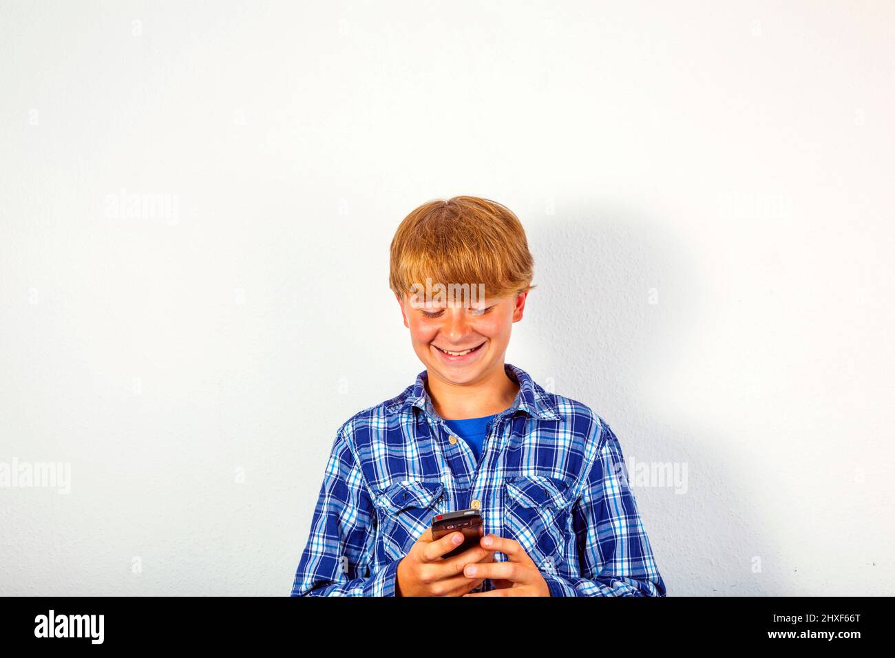 cute handsome young boy using his mobile phone Stock Photo - Alamy