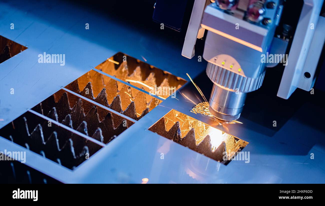 Industrial background CNC laser machine cutting sheet metal with light ...