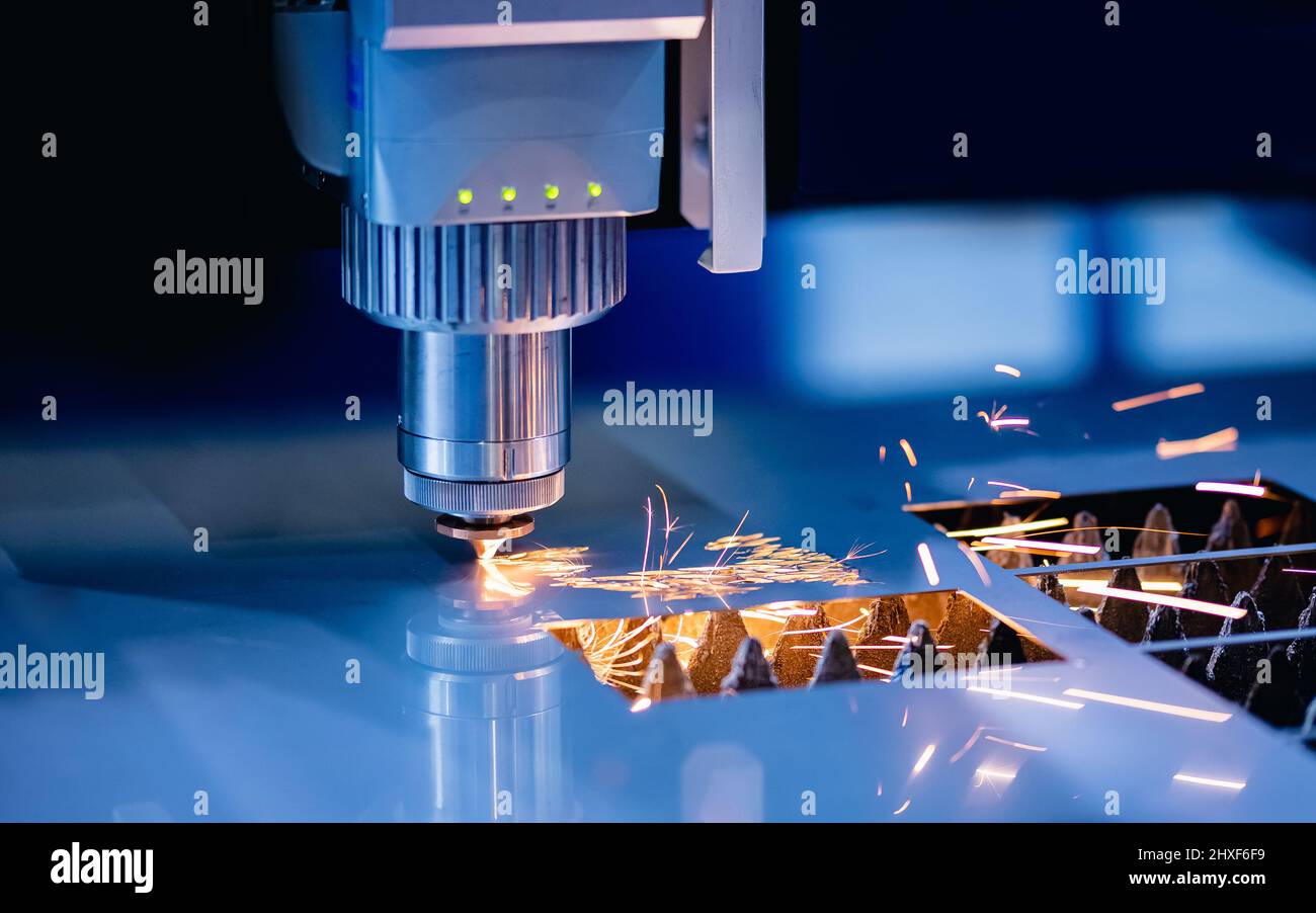 Industrial background CNC laser machine cutting sheet metal with light ...