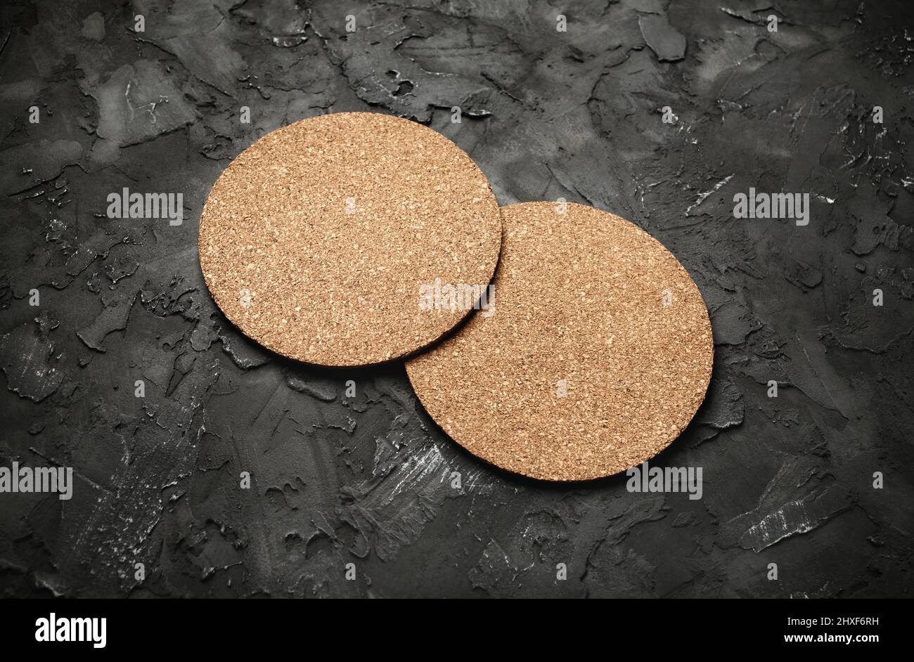 Photo of two blank cork beer coasters on black plaster background Stock ...