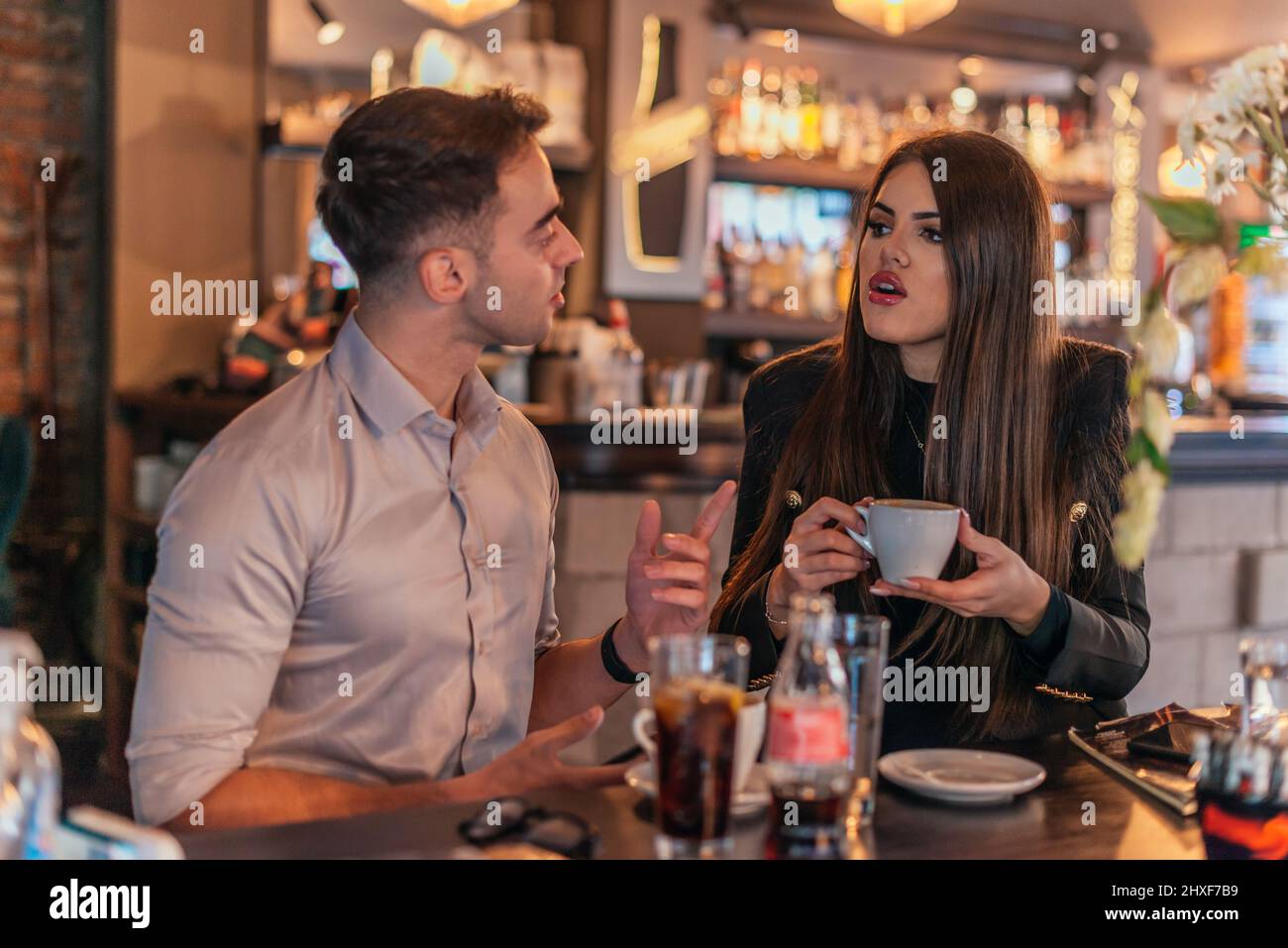 Close up picture of two business colleagues talking in a bar and ...