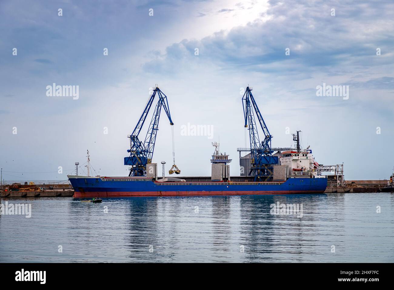 trading ship of the port city ready for loading materials with the ...