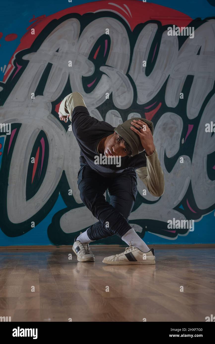 Modern rapper dancing in garage. Urban lifestyle, hip hop Stock Photo ...