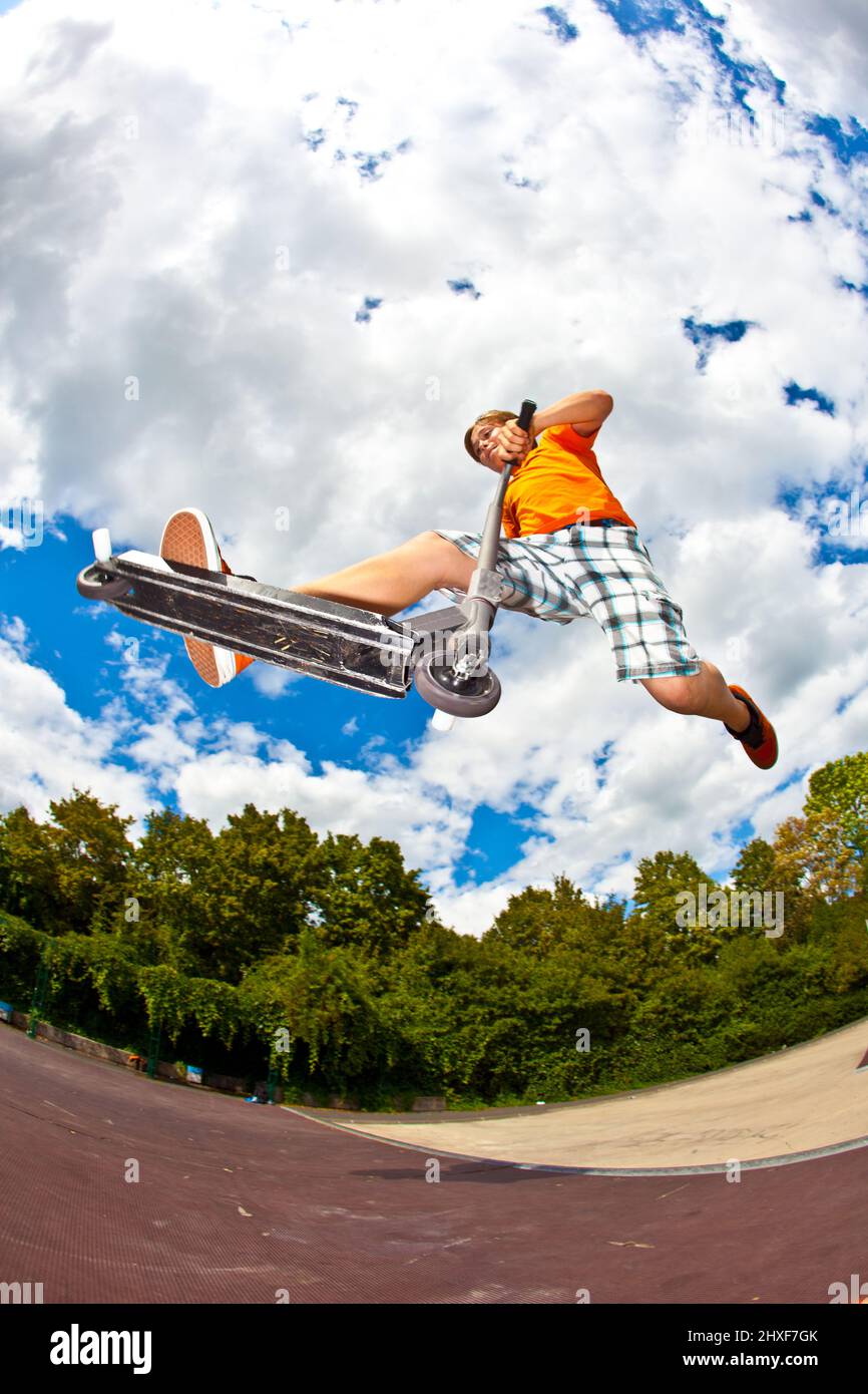 boy going airborne with his scooter Stock Photo - Alamy