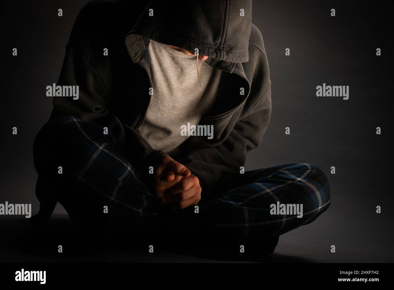 Broken boy is looking down while thinking about the pain Stock Photo ...
