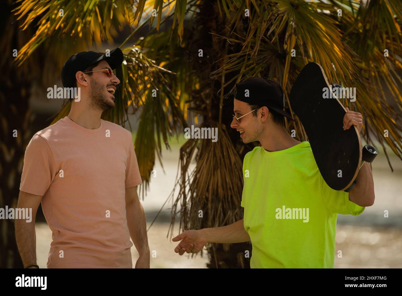 Portrait of two handsome male friends laughing under the tree Stock ...