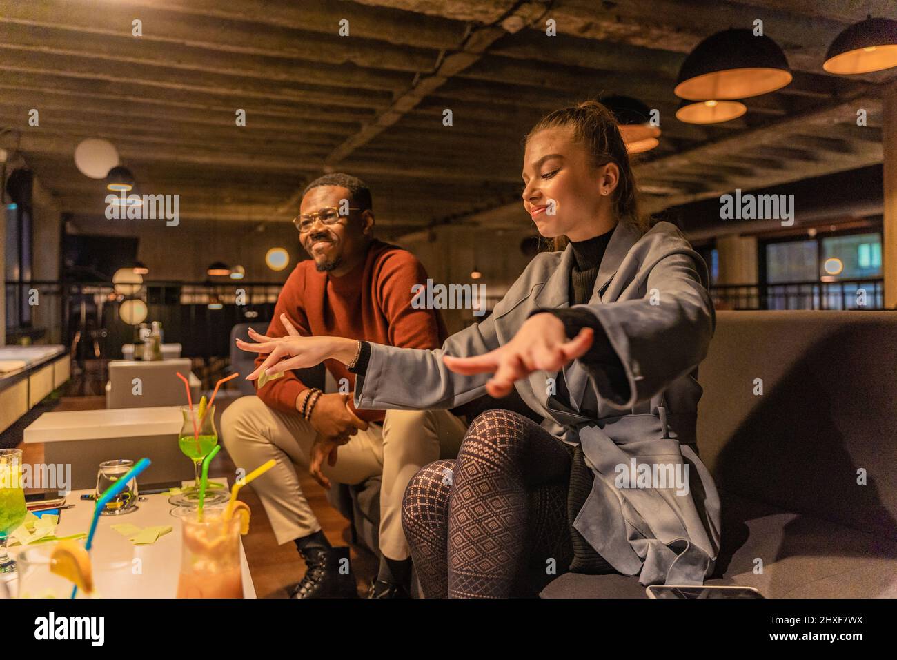 Attractive and beautiful young girl is explaining the word Stock Photo ...