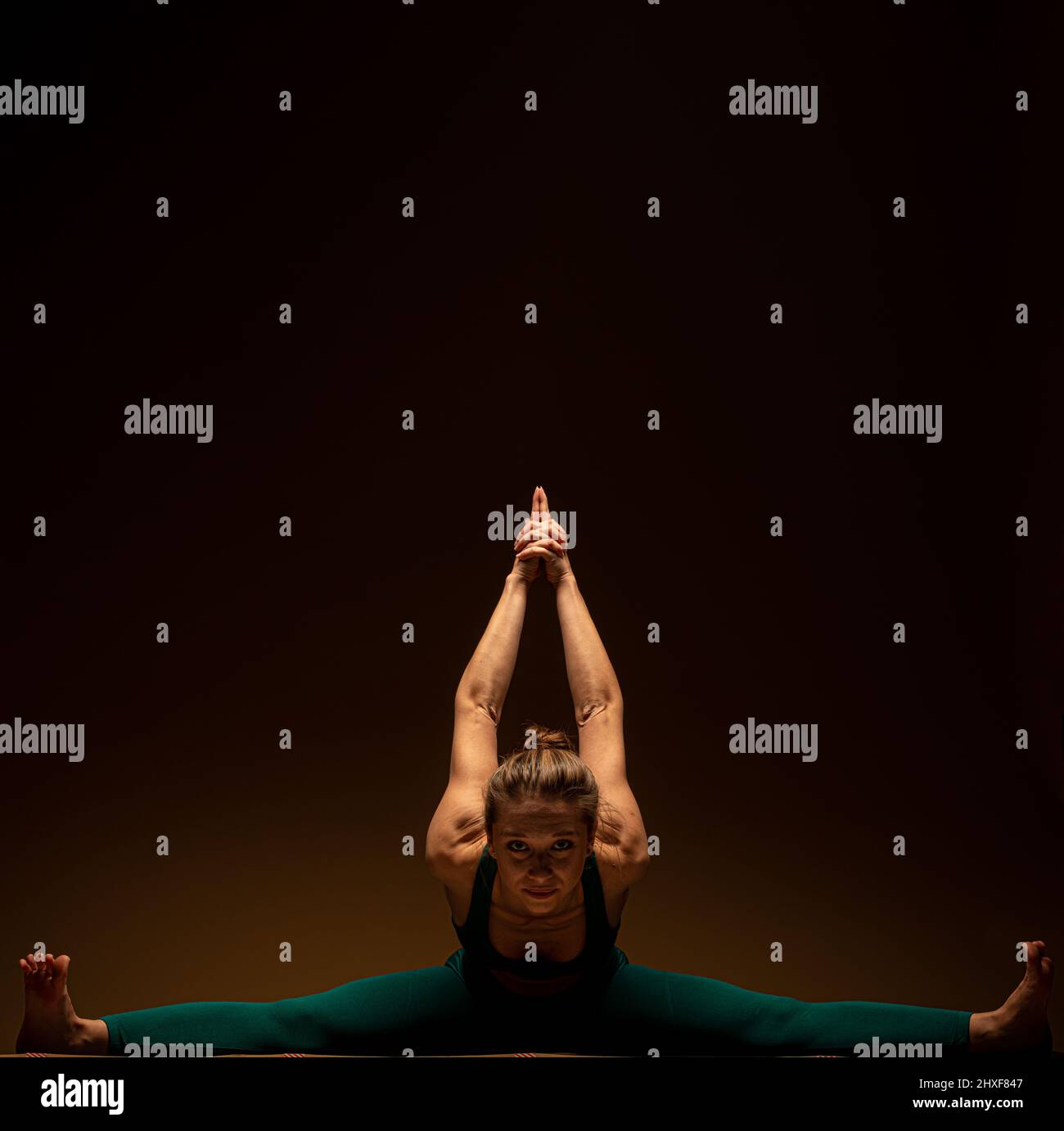 Attractive and beautiful young girl is doing splits on the ground Stock ...