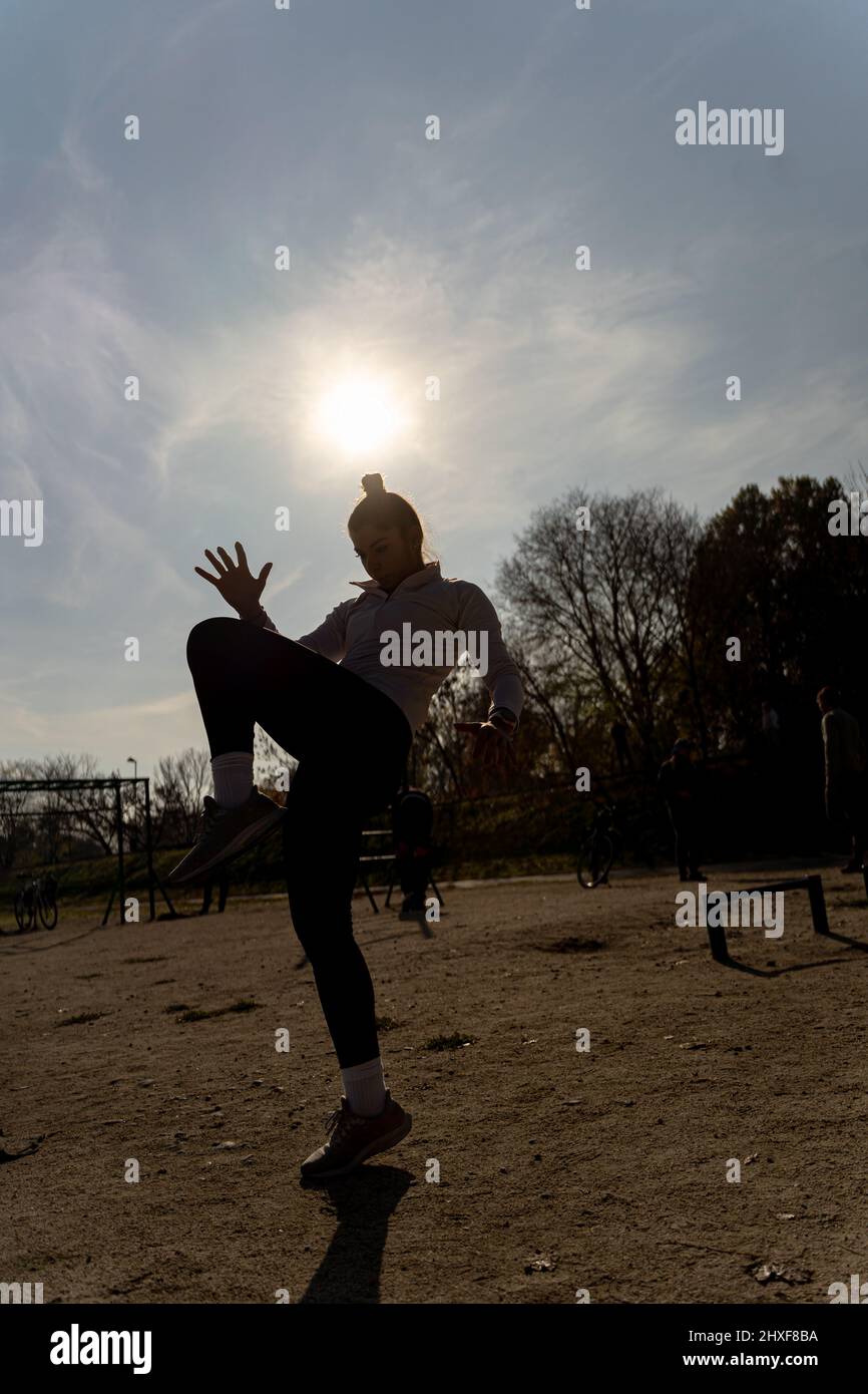 Amazing and attractive fit girl is exercising kickbox alone outside ...