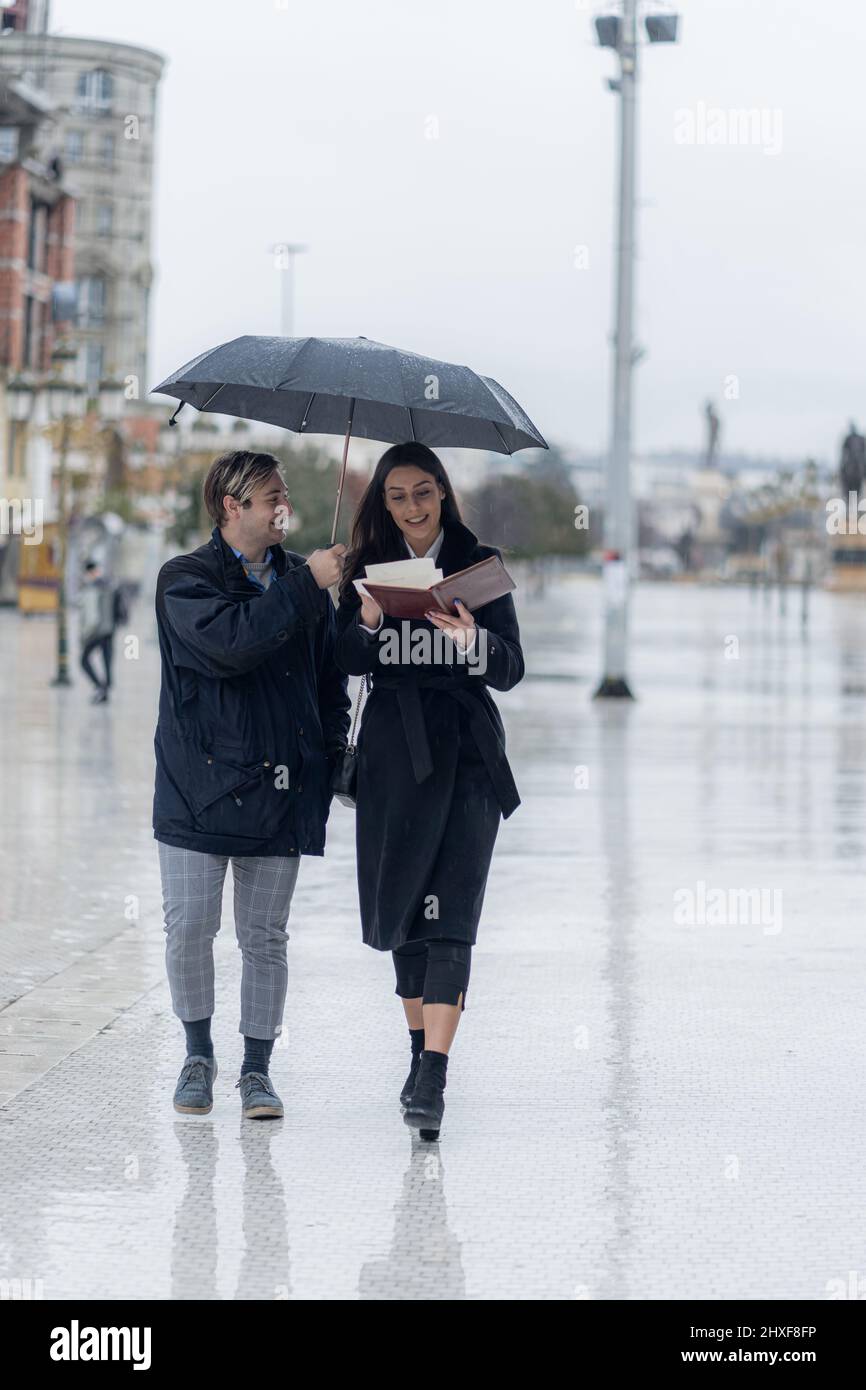 Attractive and beautiful female boss is walking with her assistent ...