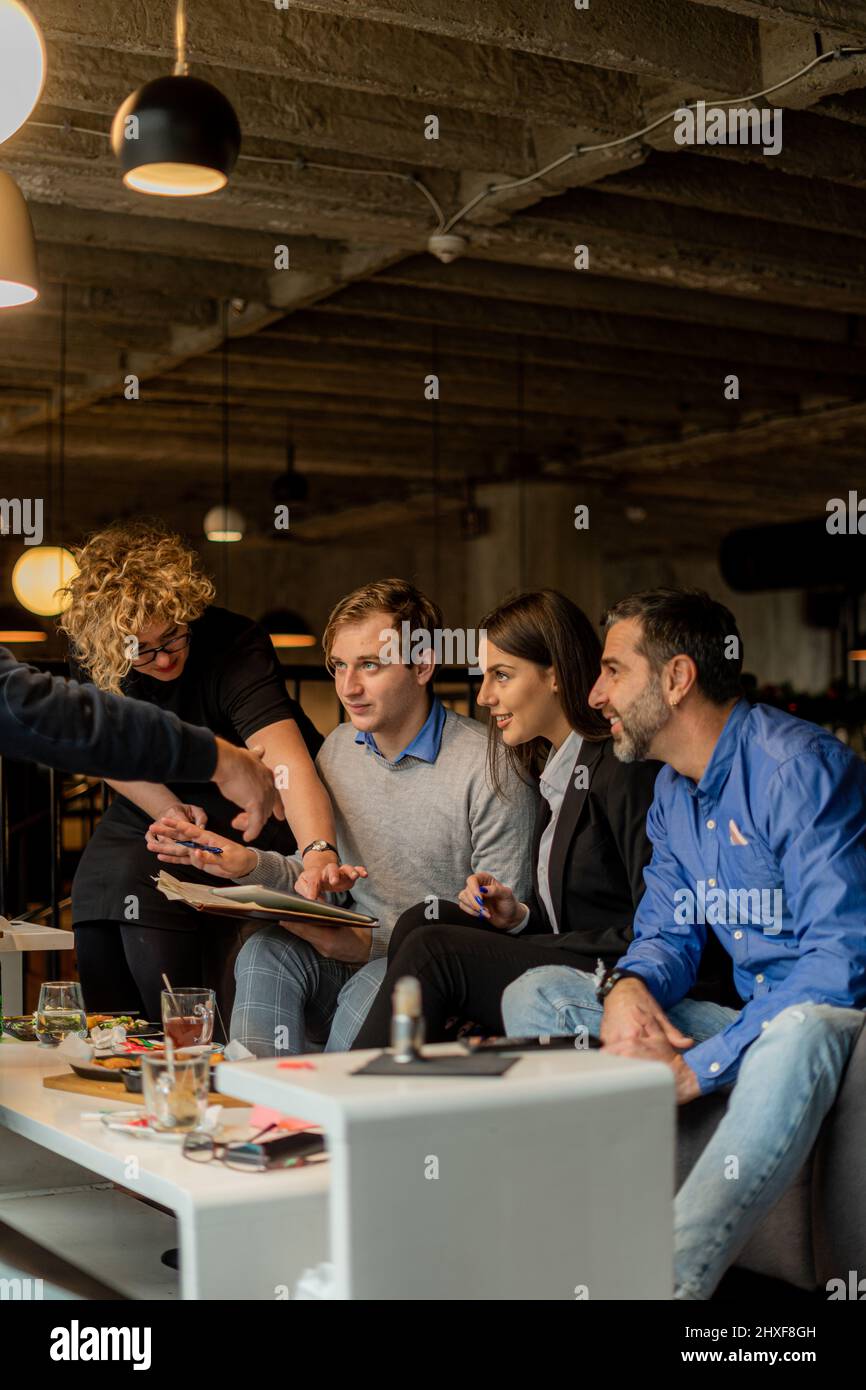 Four amazing business people are listening to their boss Stock Photo ...