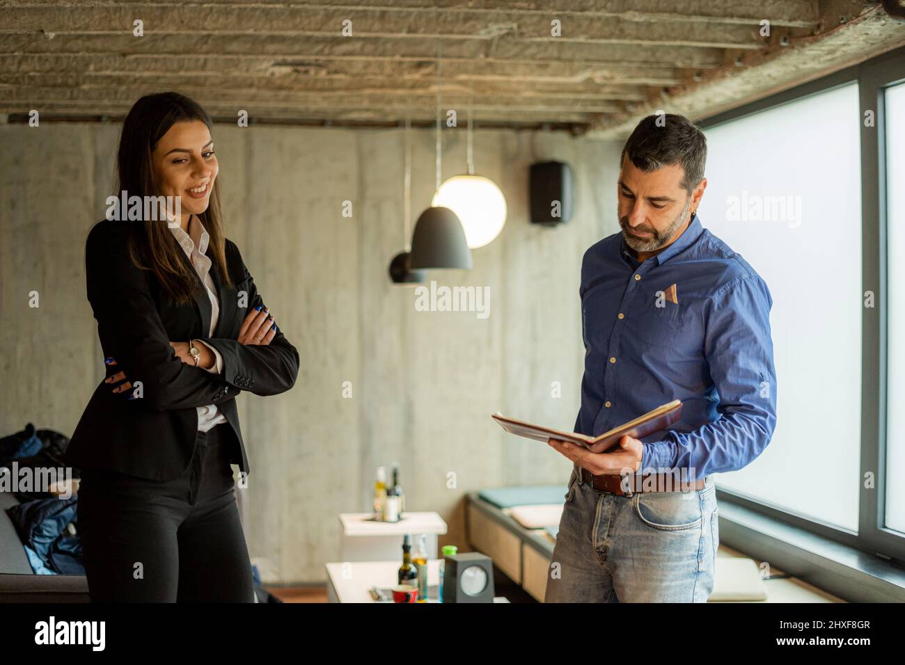 Two amazing business people are discussing the new plans and ideas for ...