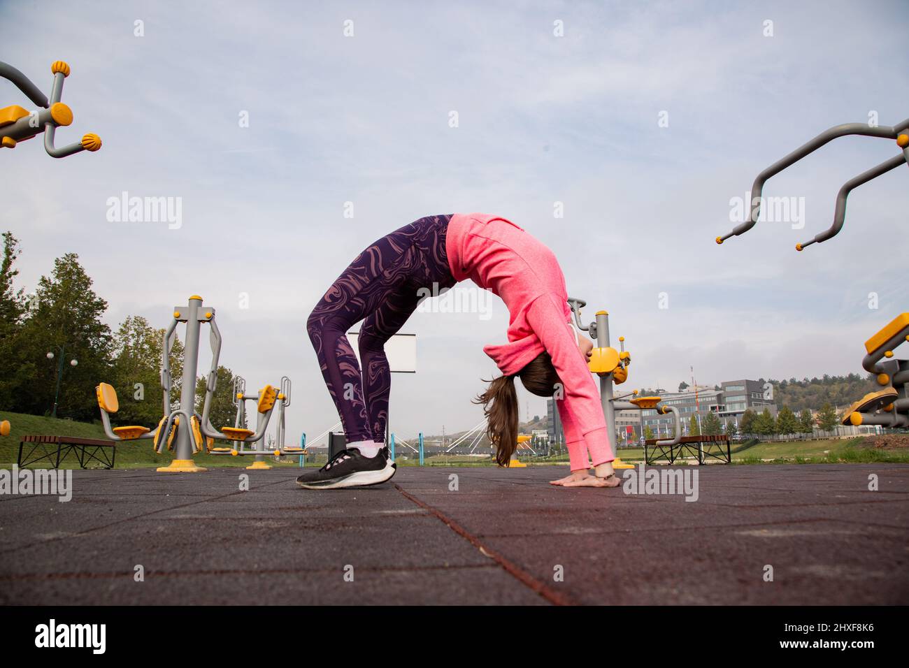 Attractive and beautiful girl is stretching her back alone Stock Photo ...