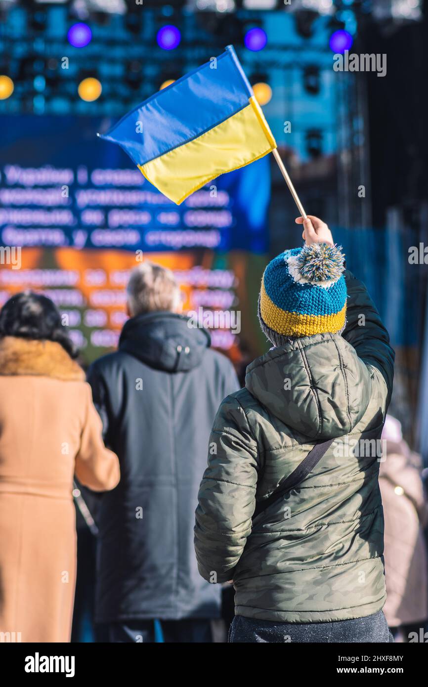 Child or kid with winter clothes, Ukrainian flag and hat, refugees ...