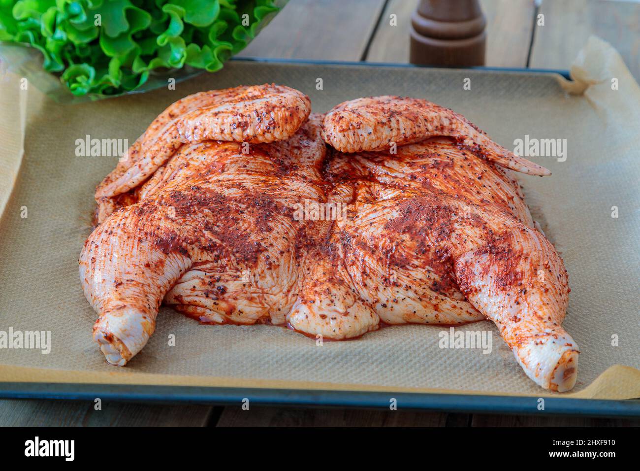 Raw whole chicken on an oven tray. chicken tobacco Stock Photo - Alamy