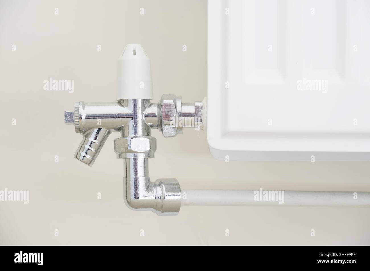 New white radiator white on pale wall house interior Stock Photo - Alamy