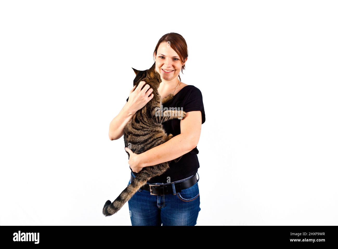 woman smiling and hugging with her cat Stock Photo - Alamy