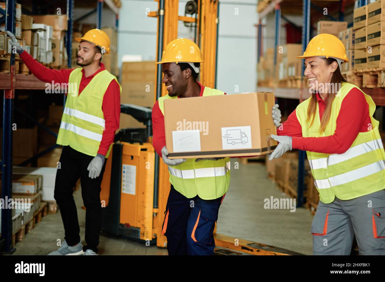 Diverse workers with carton boxes in warehouse Stock Photo - Alamy