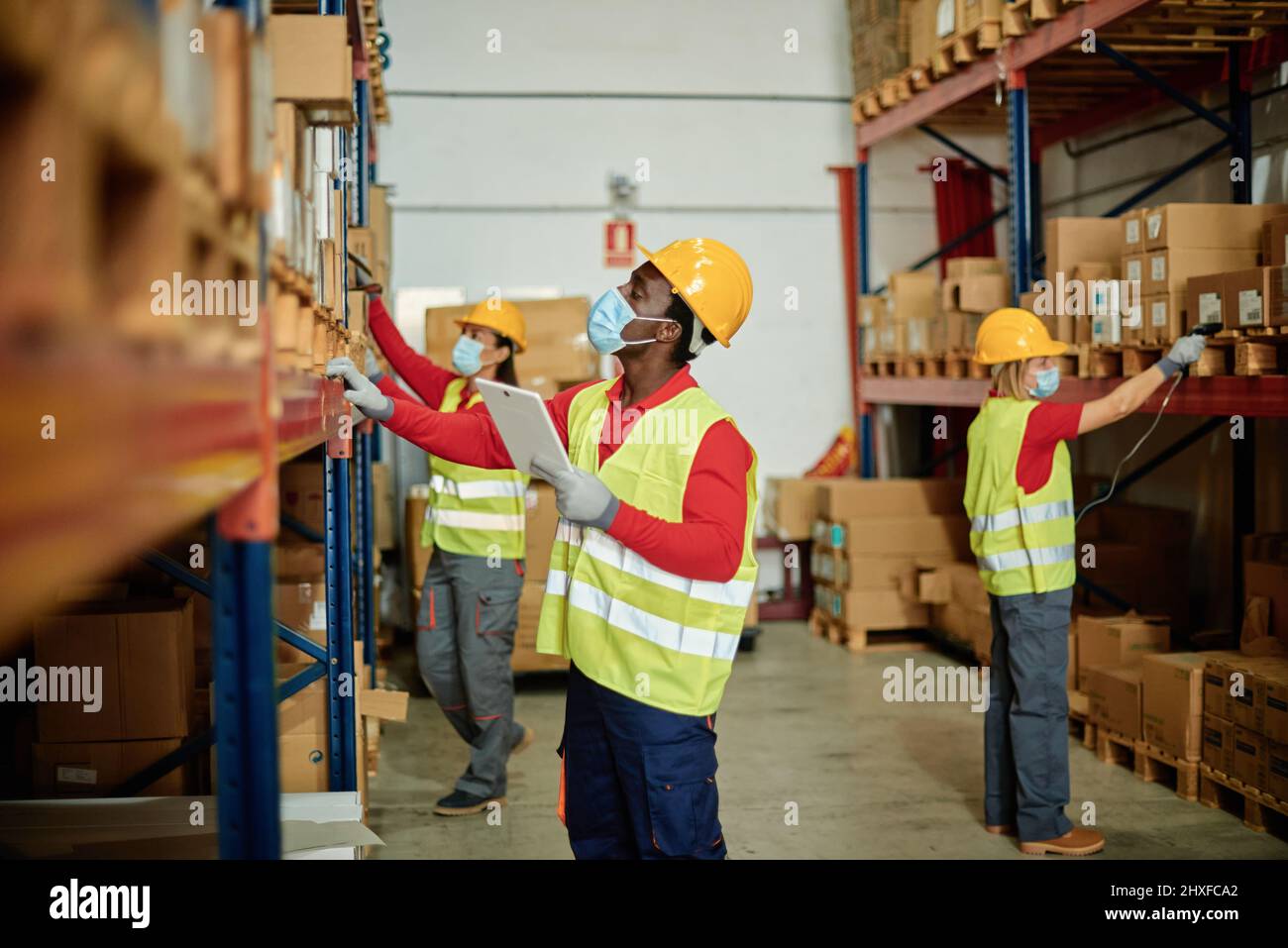 Construction workers in warehouse Stock Photo - Alamy