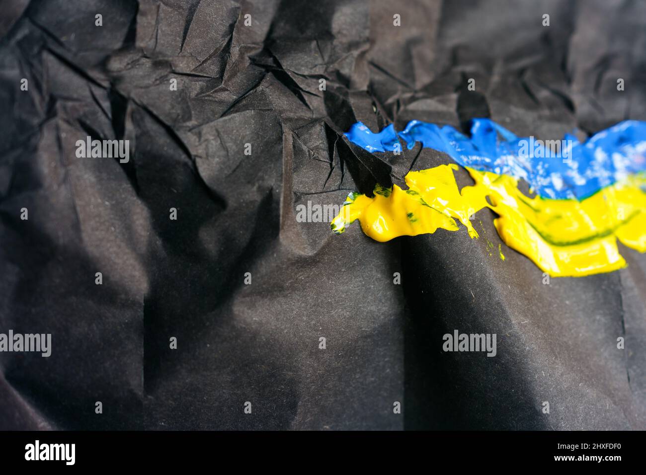 Ukraine colors at the folded black paper Stock Photo - Alamy